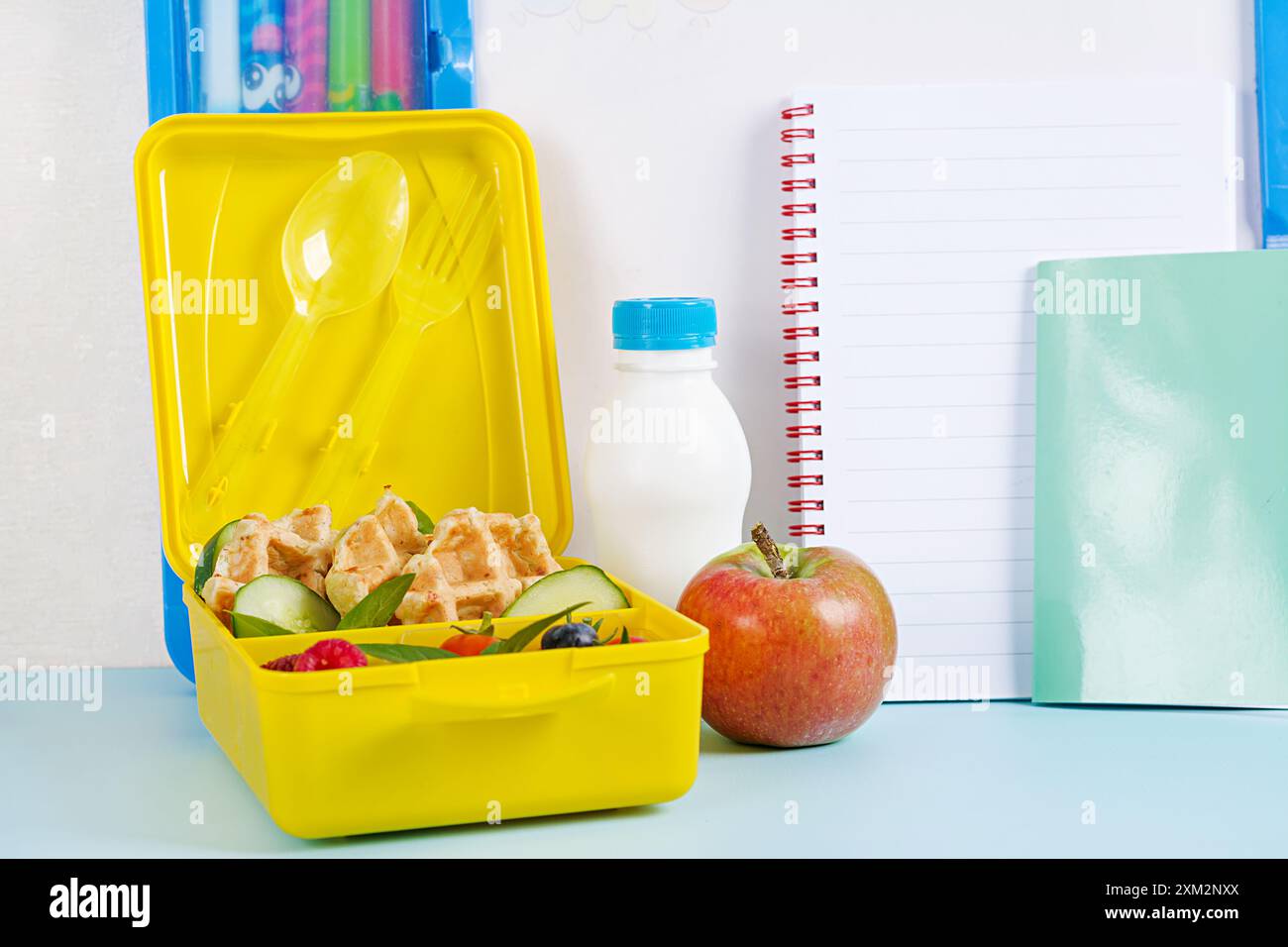 Kids lunch box with zucchini waffles, cucumber, cherry tomatoes and ...