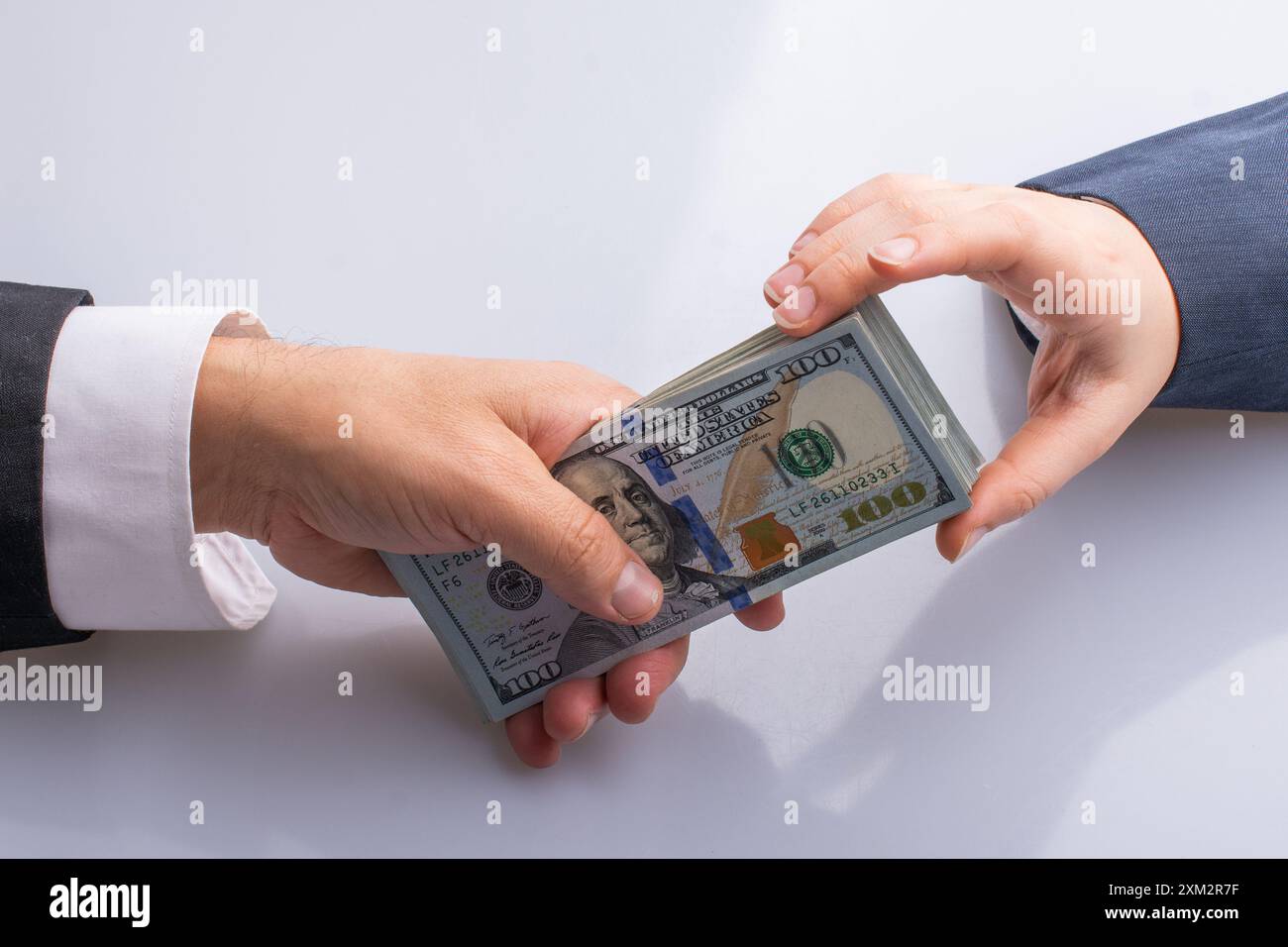 Businessman giving and receiving US dollar banknote money Stock Photo ...