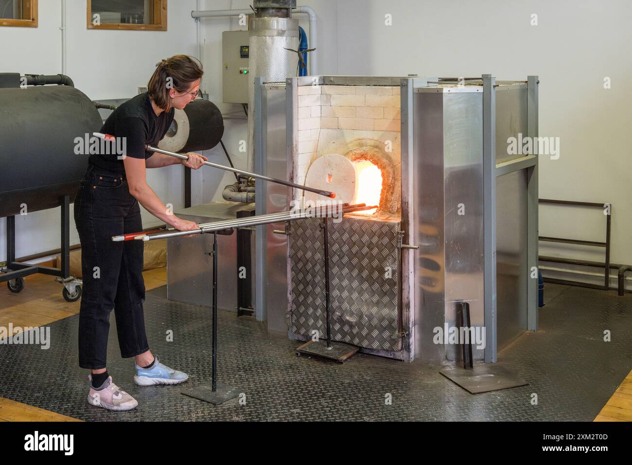 Axelle Mary, artist glassblower, working in her studio in Wales, UK ...