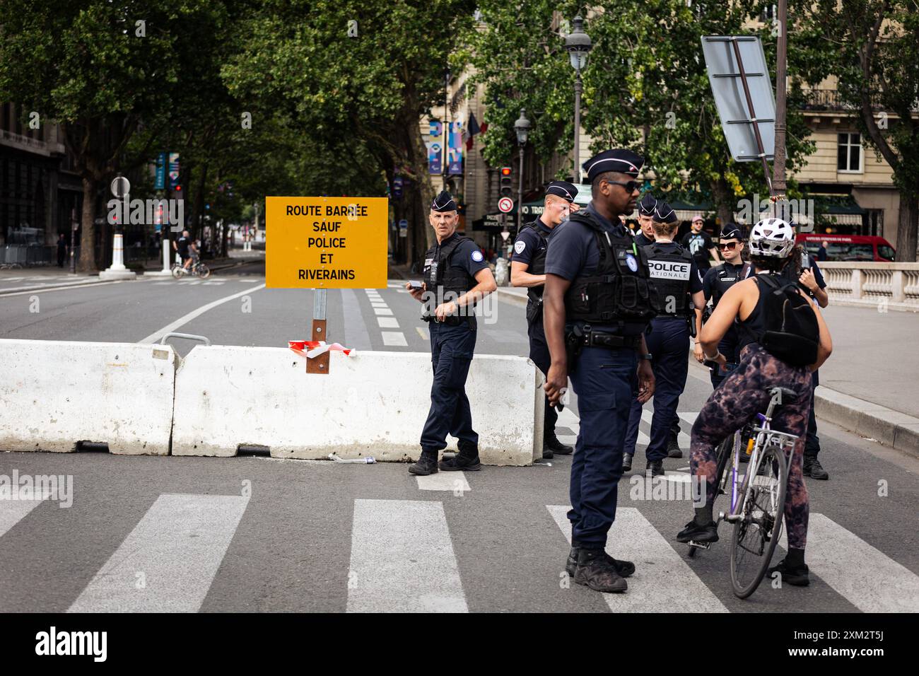 Paris, France. 23rd July, 2024. Police officers guard an entry point to ...