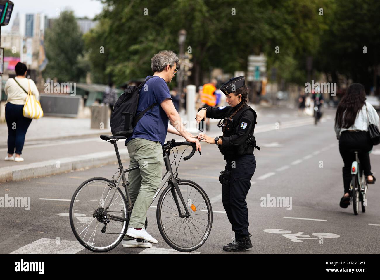 A police officer scans a cyclist's qr code at one of the entrances to ...