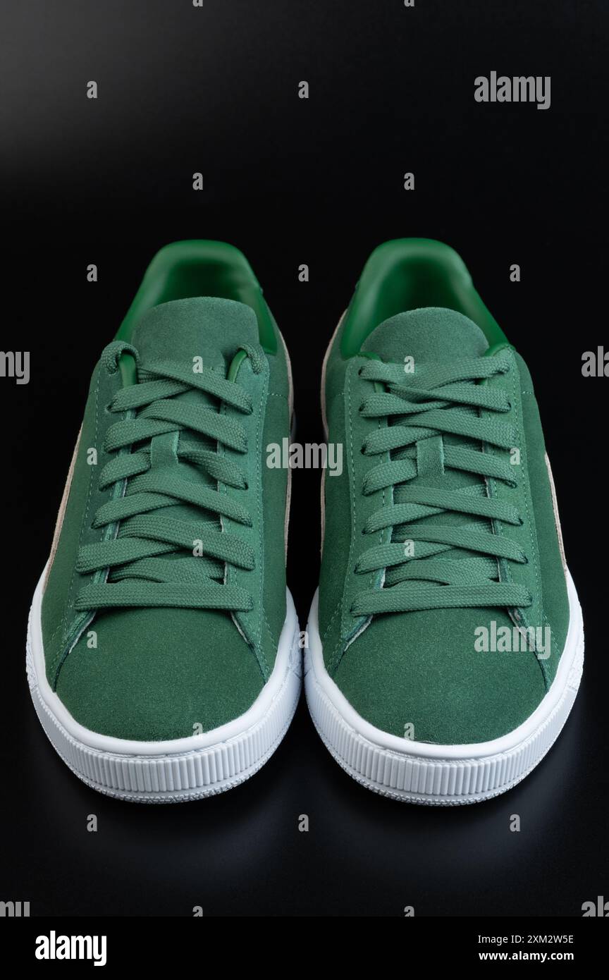 Classic green pair shoes front view isolated on black studio background ...