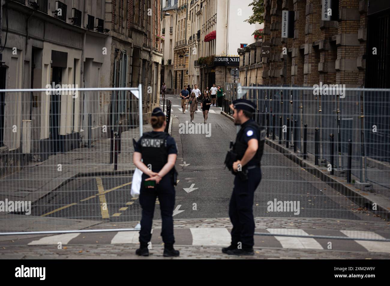Paris, France. 23rd July, 2024. Police officers guard an entry point to ...