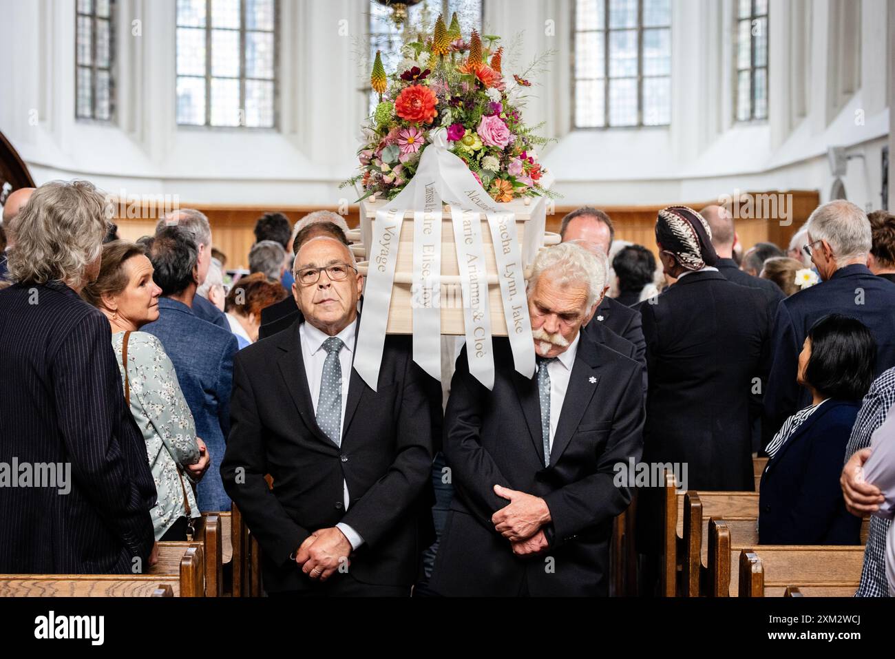 THE HAGUE - Relatives carry the coffin outside during the farewell of ...