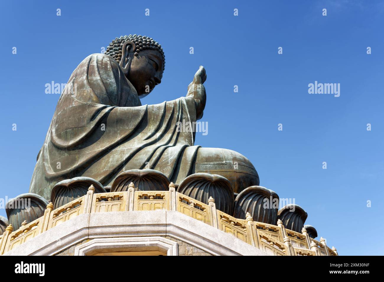 Side view of Tian Tan Buddha on the blue sky background in Hong Stock ...