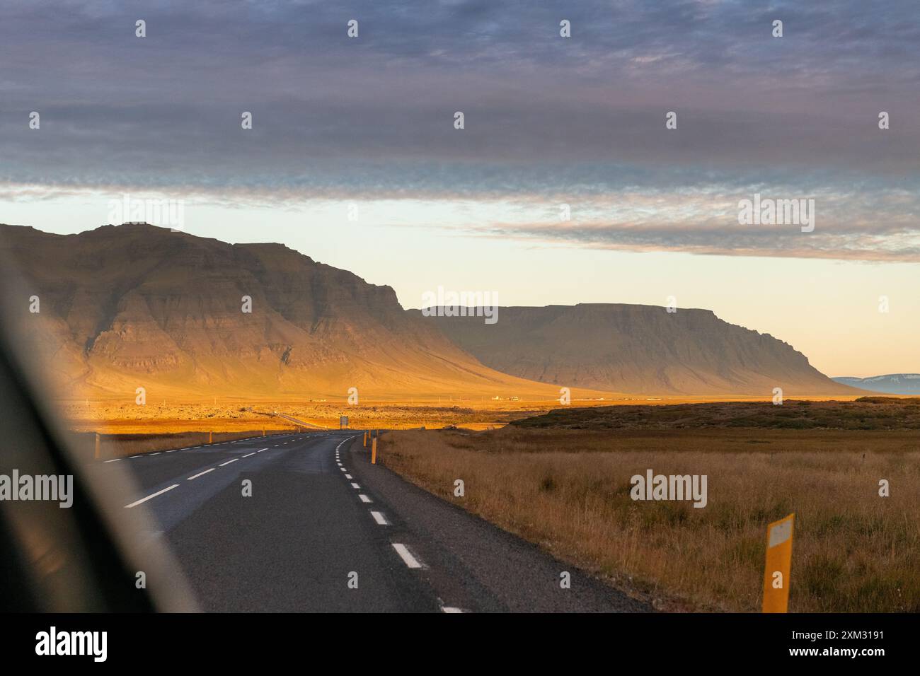 Scenic drive through mountains at golden hour with dramatic clouds ...