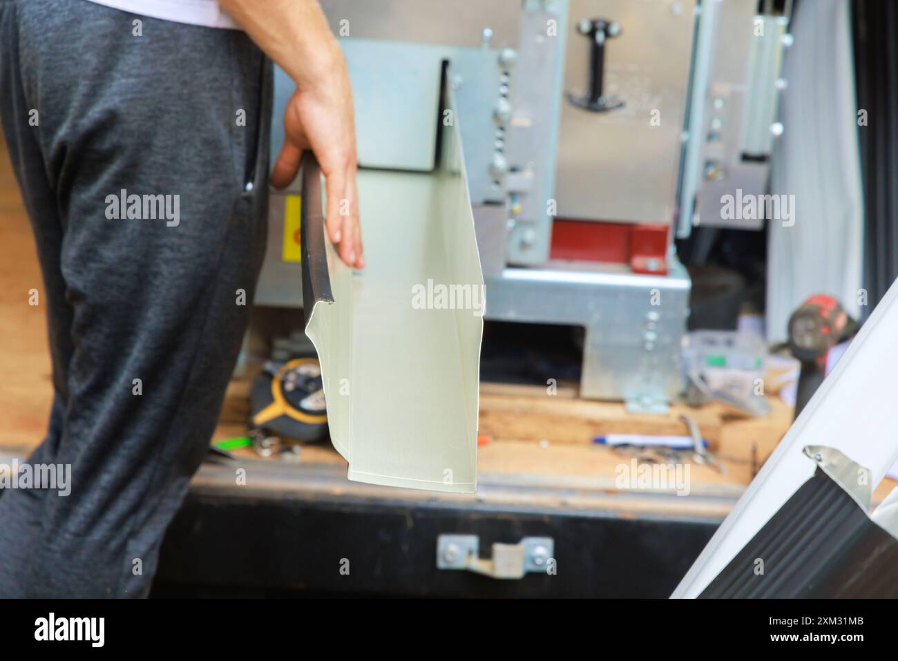 Using bending machine tool, thin metal rain gutters may be bent Stock ...