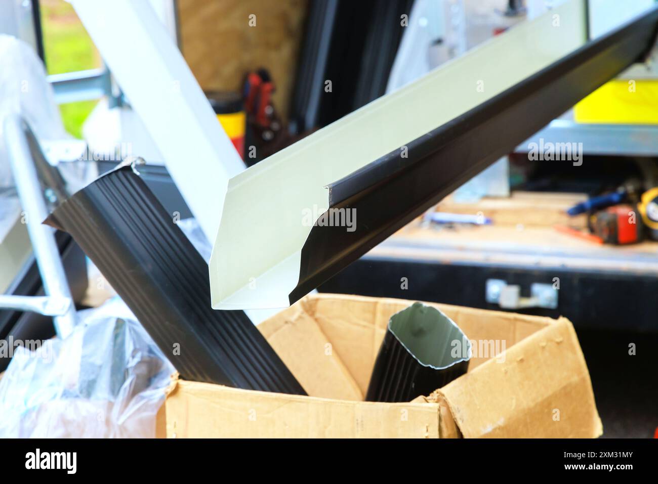 Using bending machine tool, rain gutters made of thin metal are bent ...