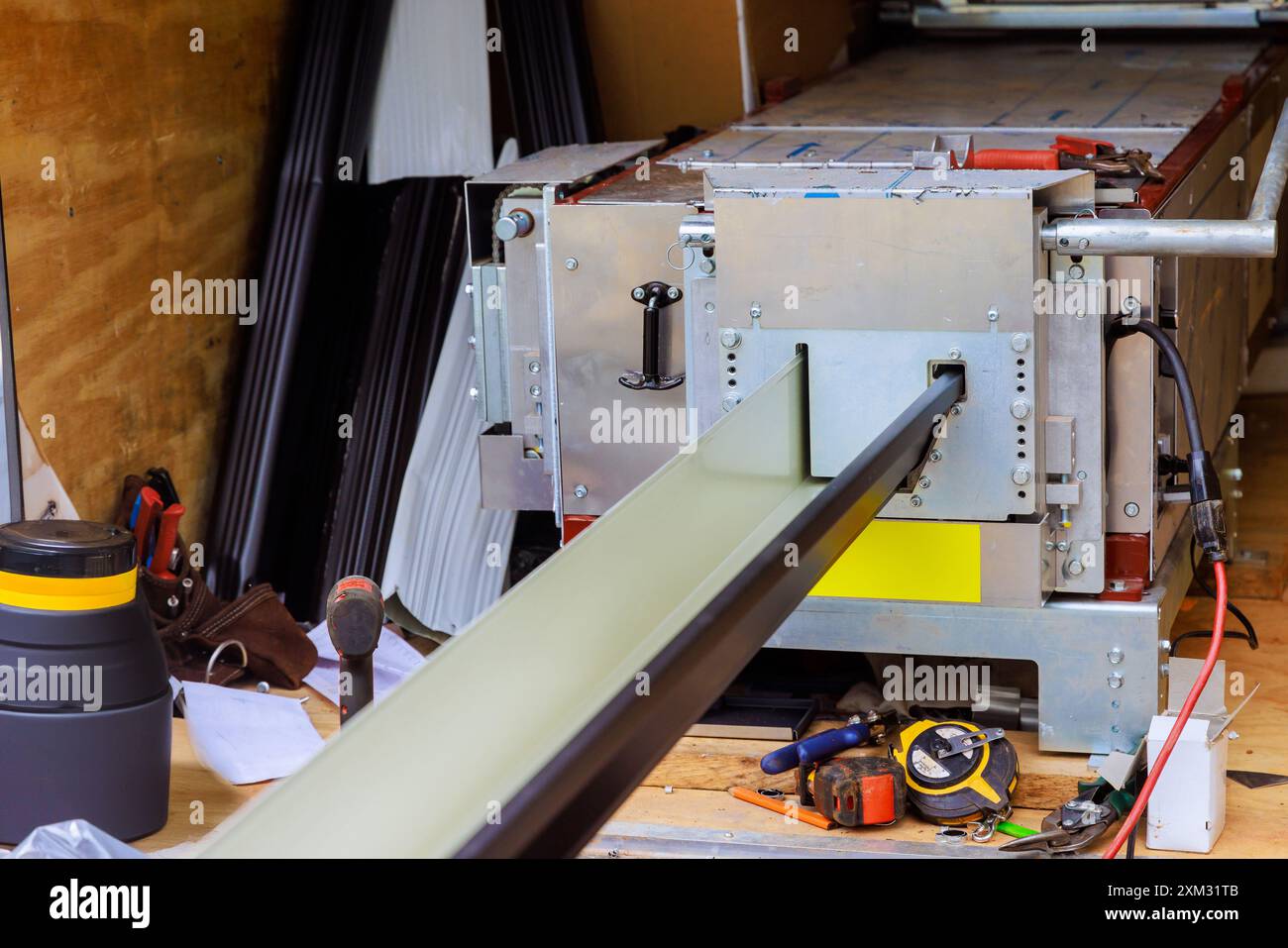 An automatic bending machine is used to bend rain gutters made of thin ...