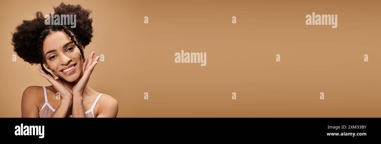 A beautiful young African American woman smiles brightly, her hands ...