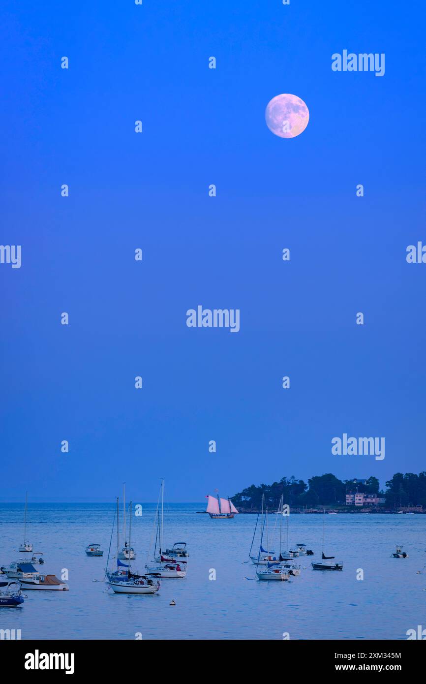 Creamsicle Buck Moon Rising Over the Channel with Schooner Stock Photo ...