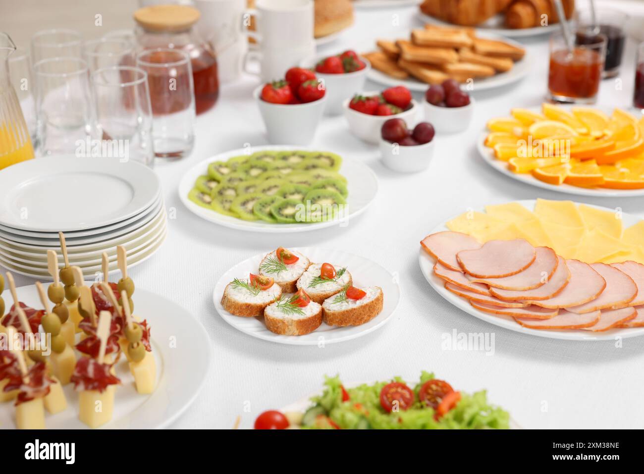 Different meals served on white table indoors. Buffet menu Stock Photo ...