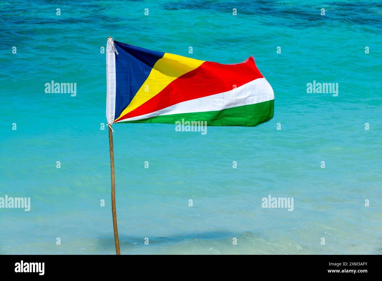 Seychelles flag on a beach, turquoise water background Stock Photo - Alamy