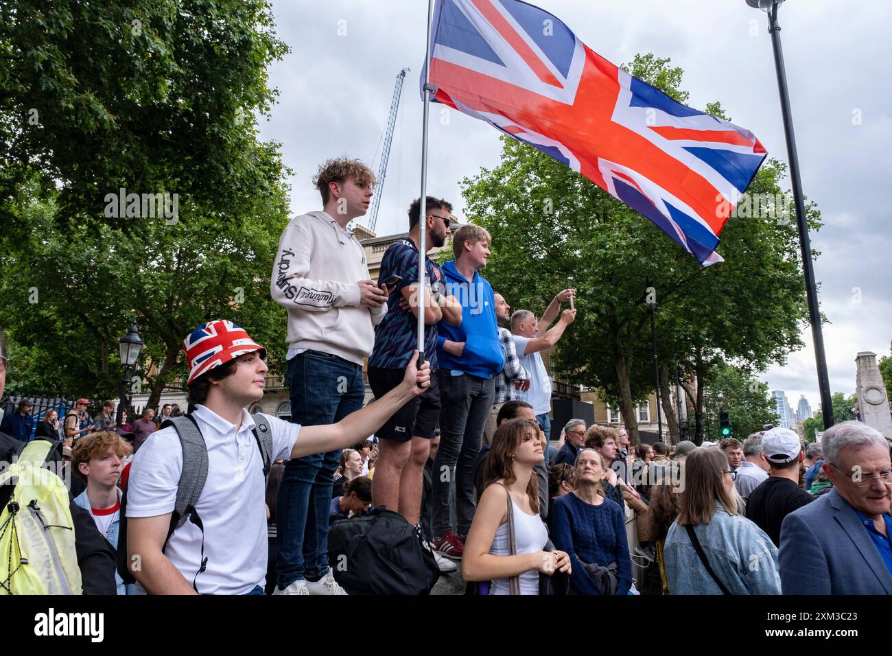 People gather outside Downing Street on the day that the outgoing ...