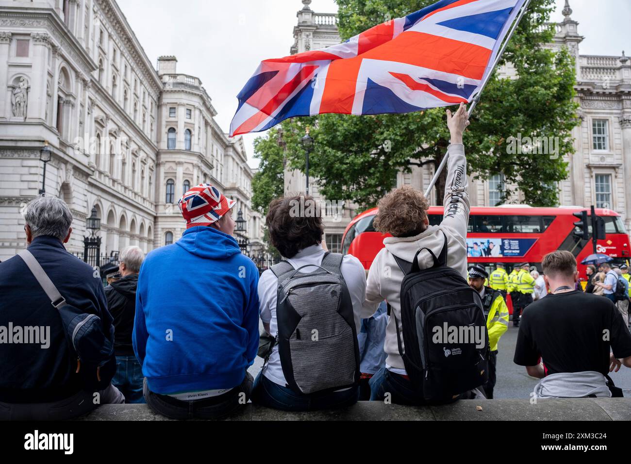 People gather outside Downing Street on the day that the outgoing ...