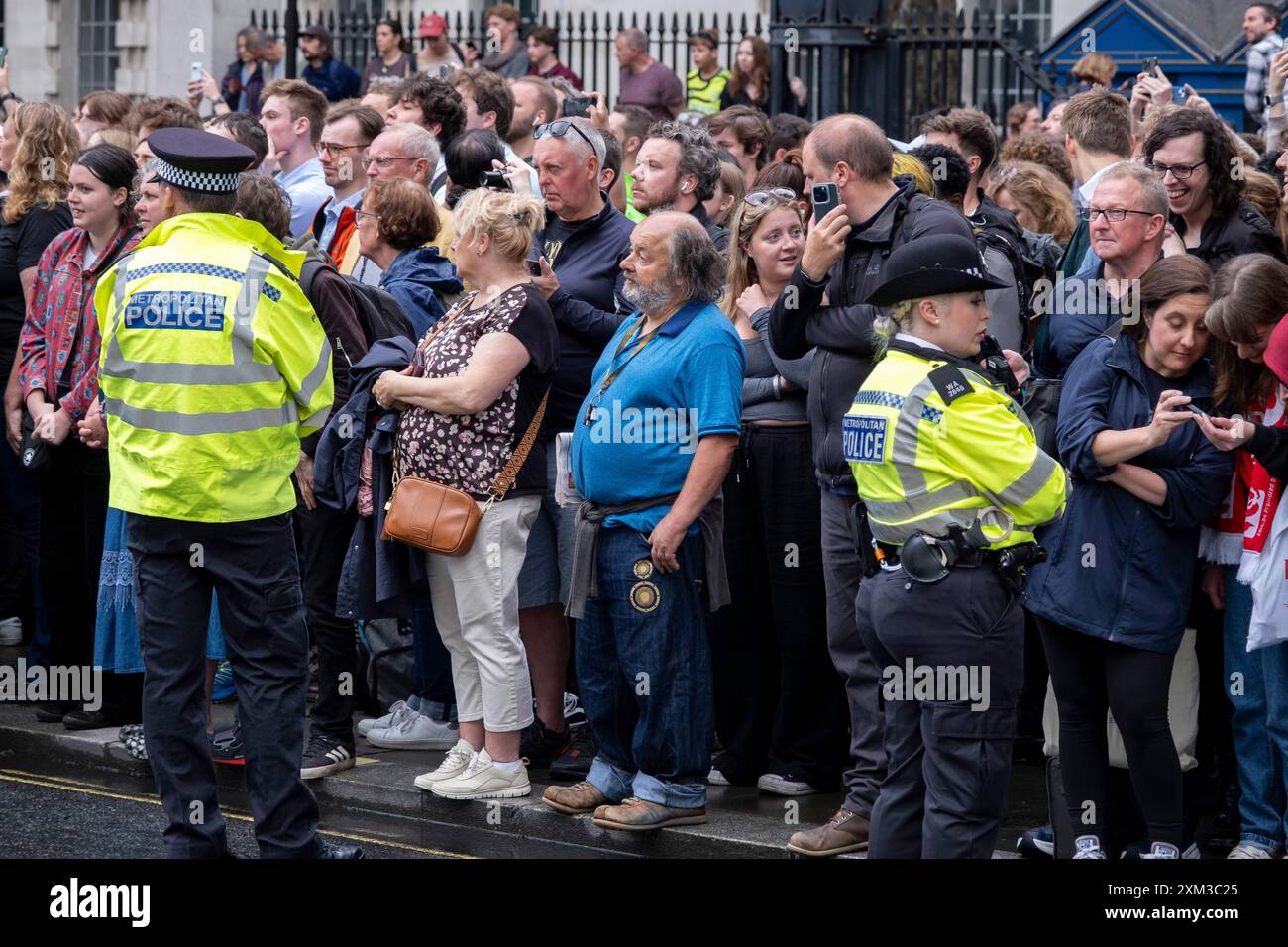 People gather outside Downing Street on the day that the outgoing ...