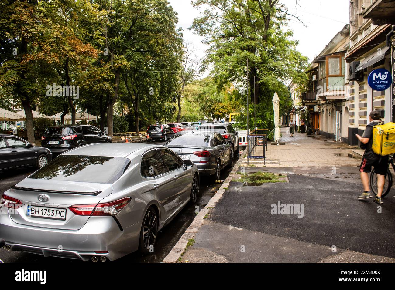 Odessa, Ukraine, July 25, 2024 Cityscape, cars parked in the street of ...