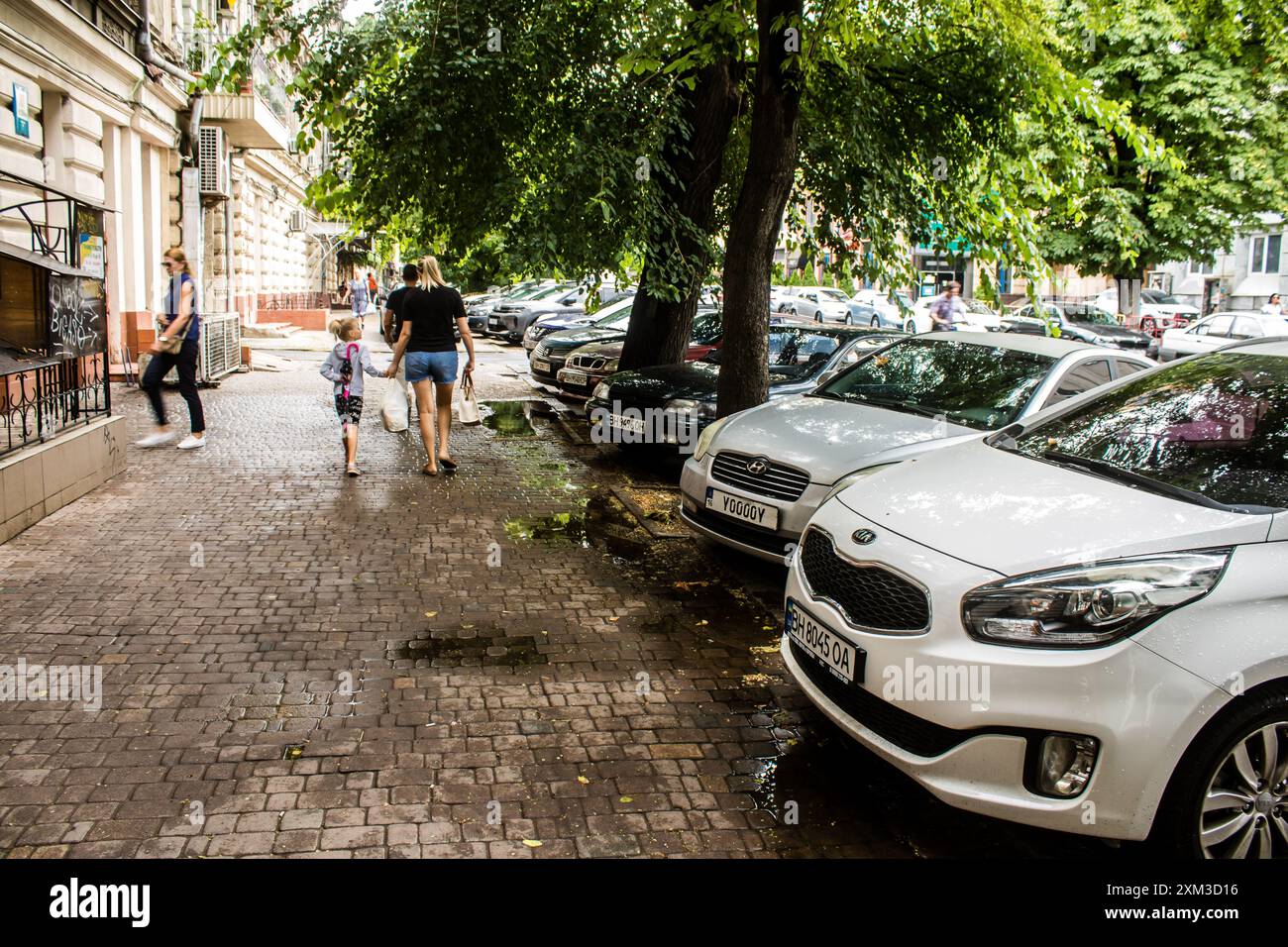 Odessa, Ukraine, July 25, 2024 Cityscape, cars parked in the street of ...