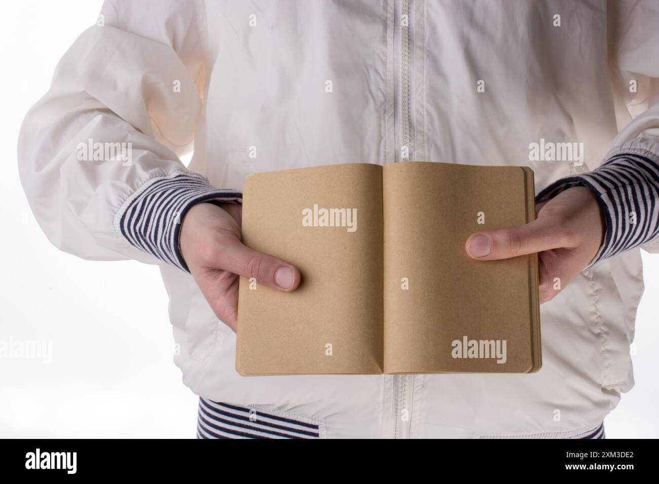 Hand holding a notebook on a white background Stock Photo - Alamy