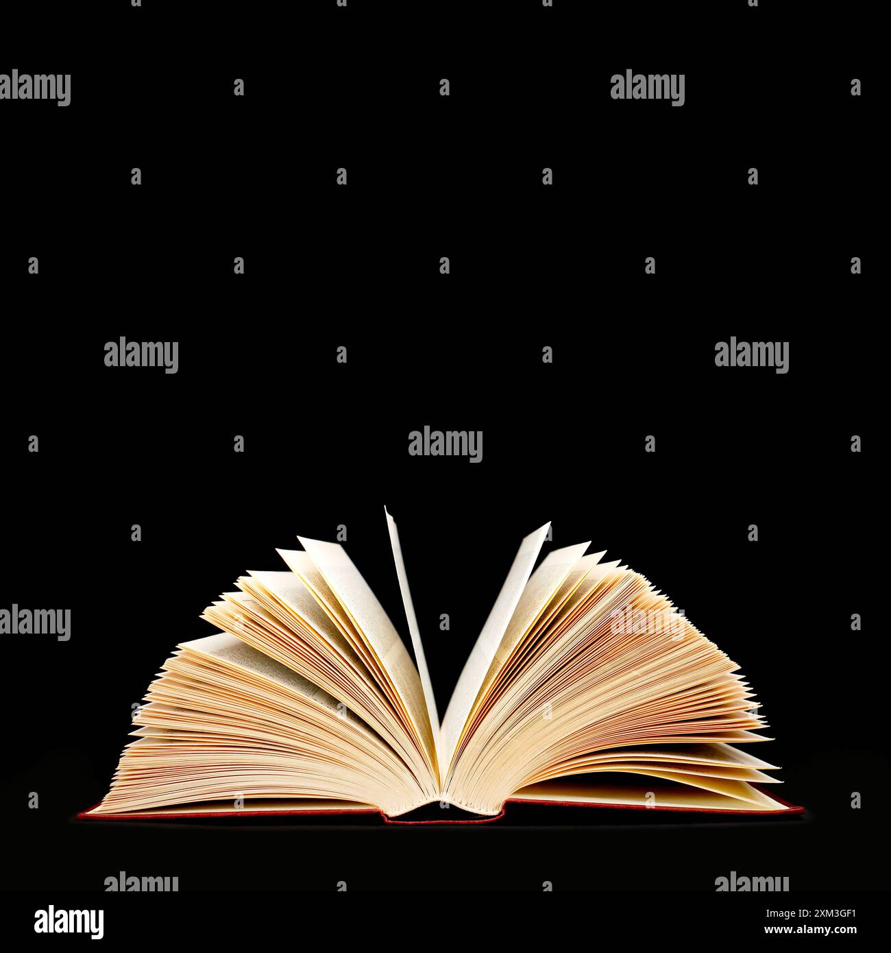 Open old Book on black background Stock Photo - Alamy