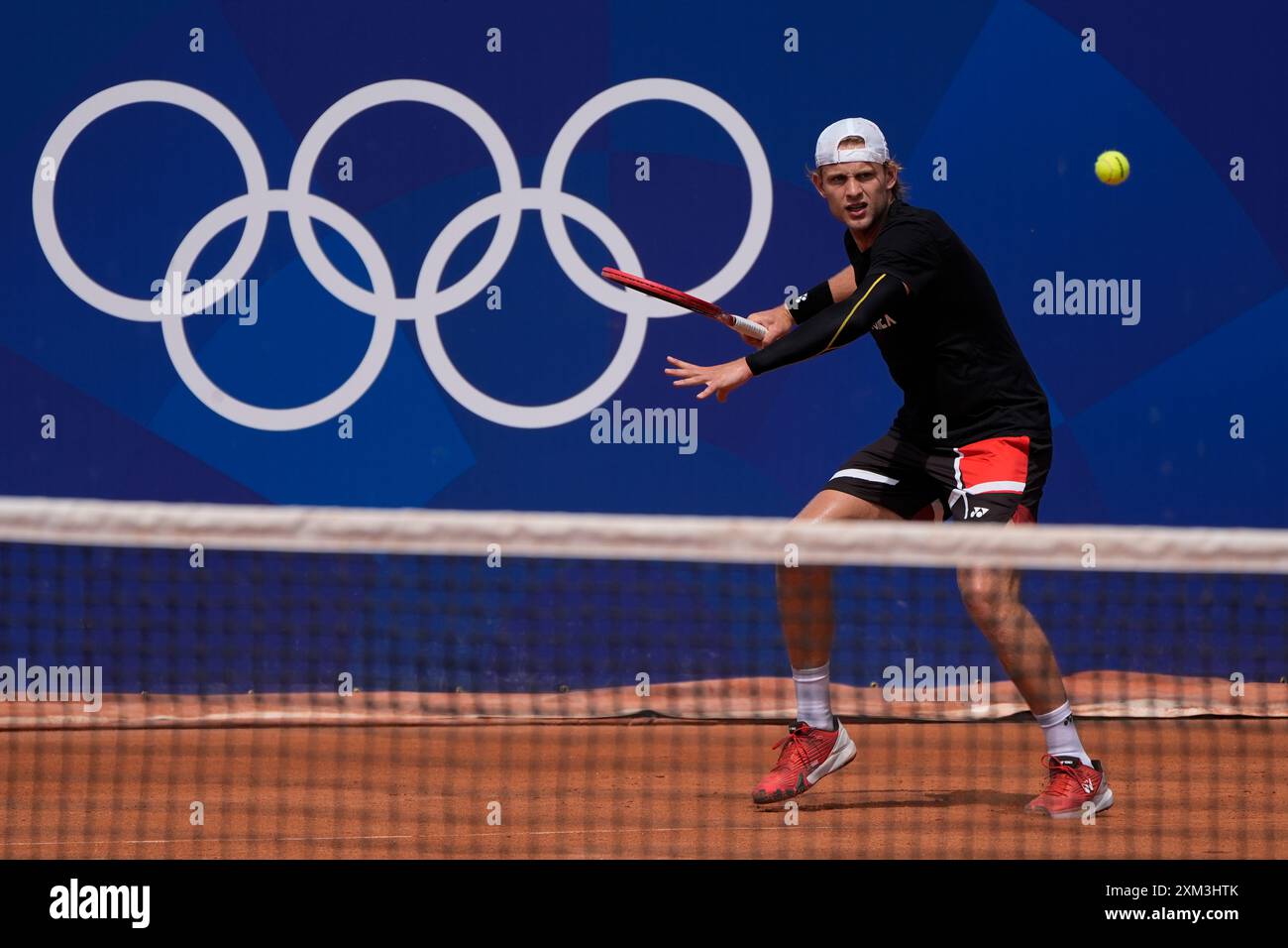Zizou Bergs of Belgium returns the ball during a practice session with ...