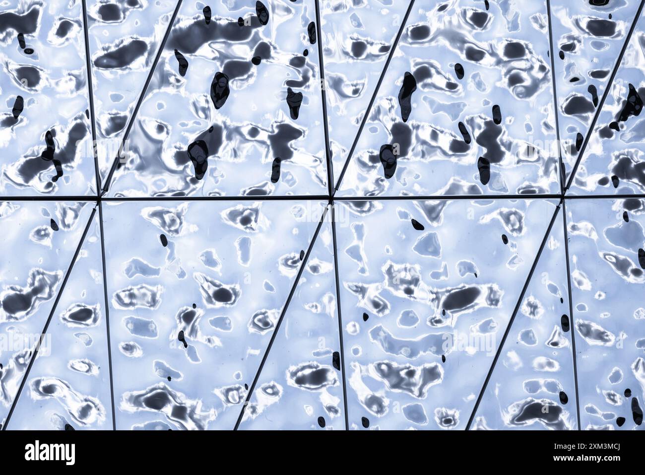 Blue shiny metal wall structure with gaps between shiny steel plates ...