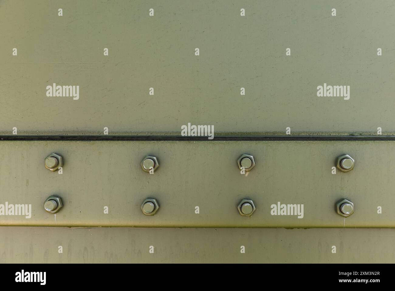 Military green wall with bolts, background photo texture. Steel details ...