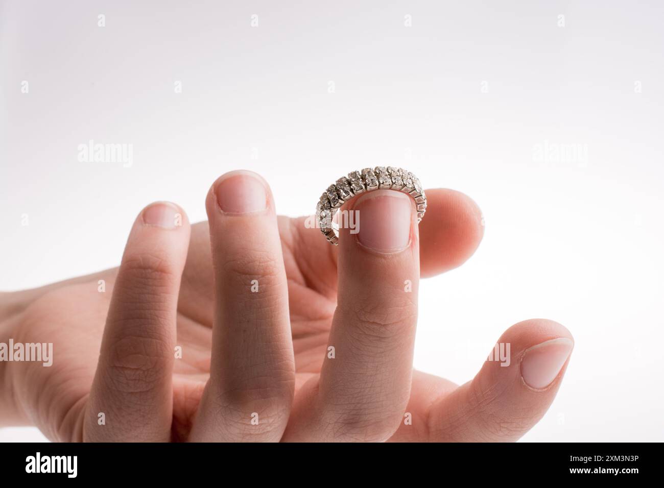 Hand wearing a ring on a white background Stock Photo - Alamy