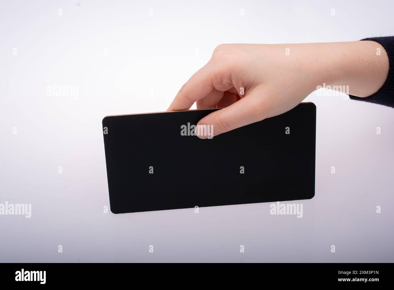 Rectangular shaped black notice board in hand on white background Stock ...