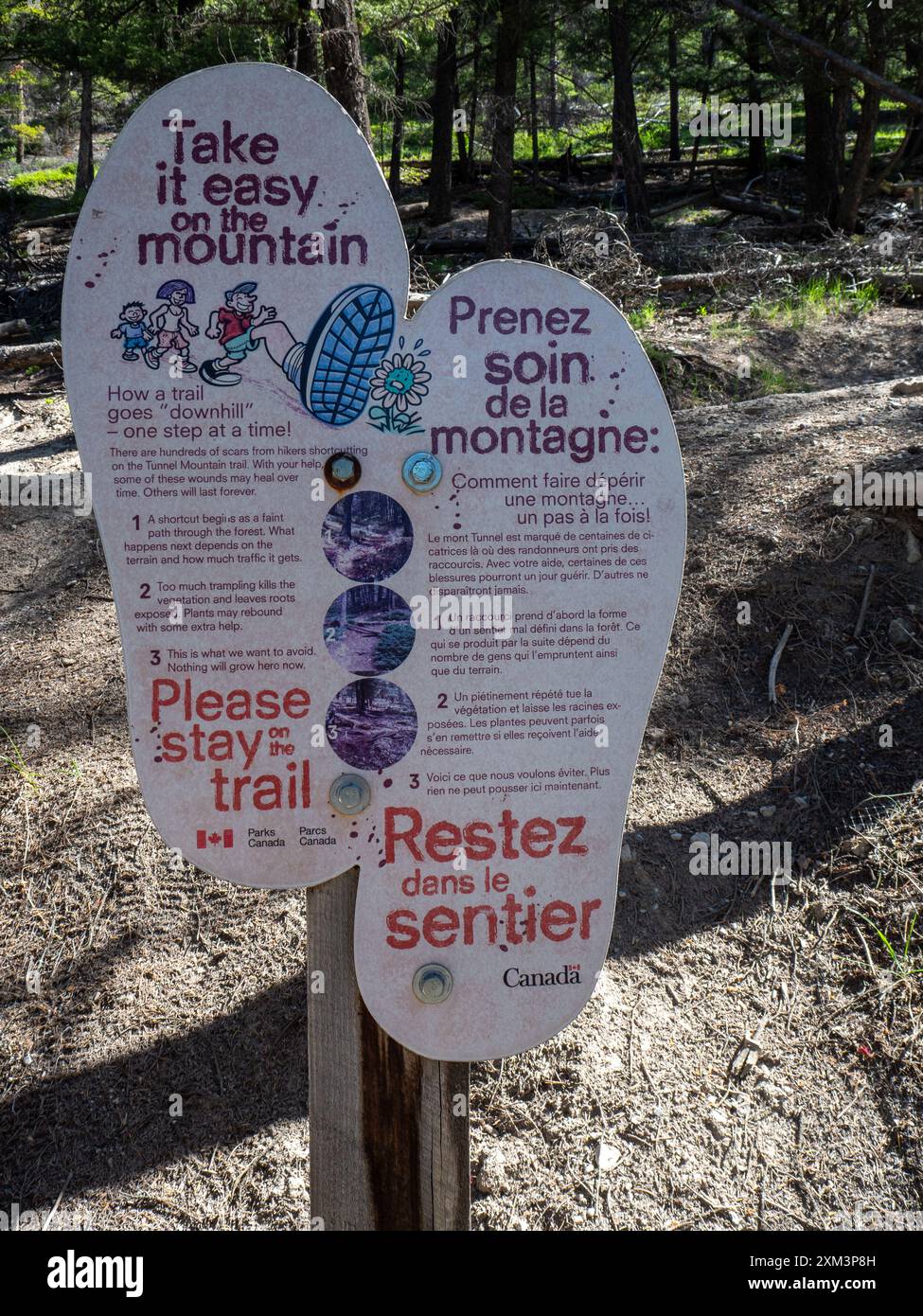 Bi lingual mountain rules sign. Tunnel mountain, Banff Stock Photo - Alamy