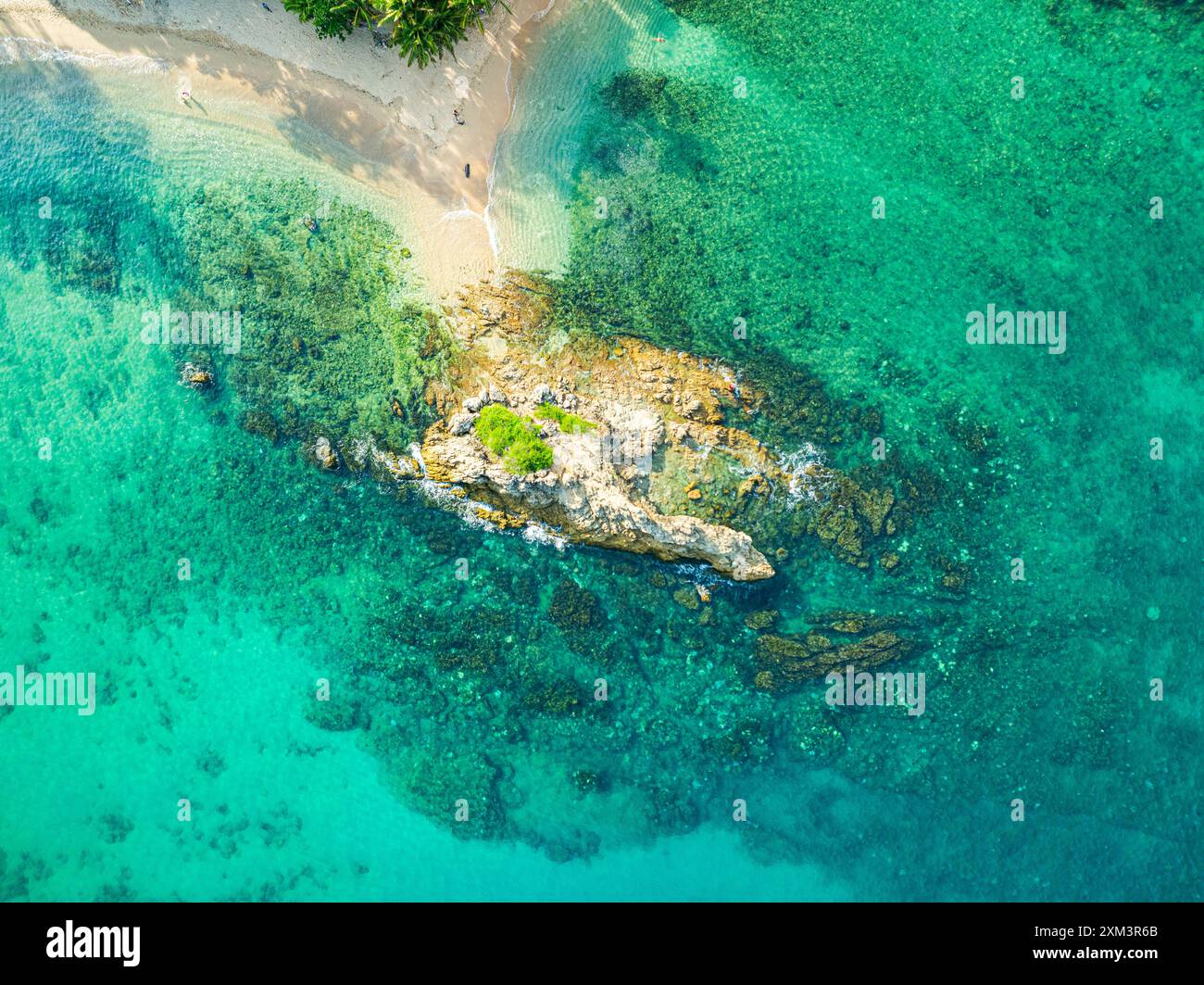 aerial top view above small island in front of Yanui beach in low tide ...