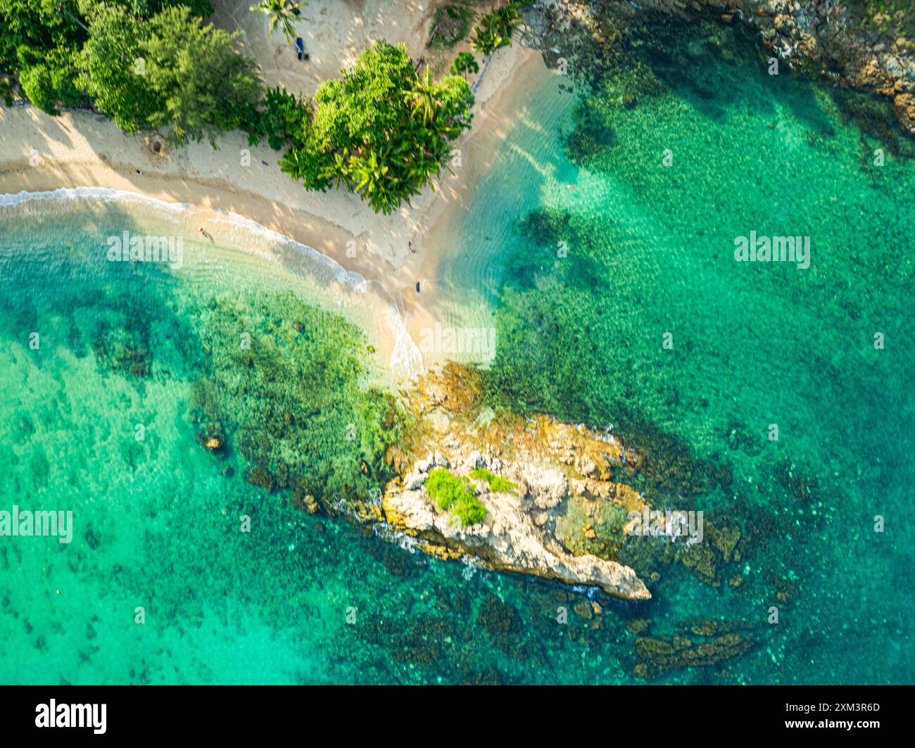 aerial top view above small island in front of Yanui beach in low tide ...