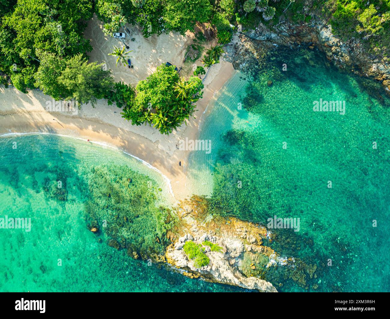 aerial top view above small island in front of Yanui beach in low tide ...