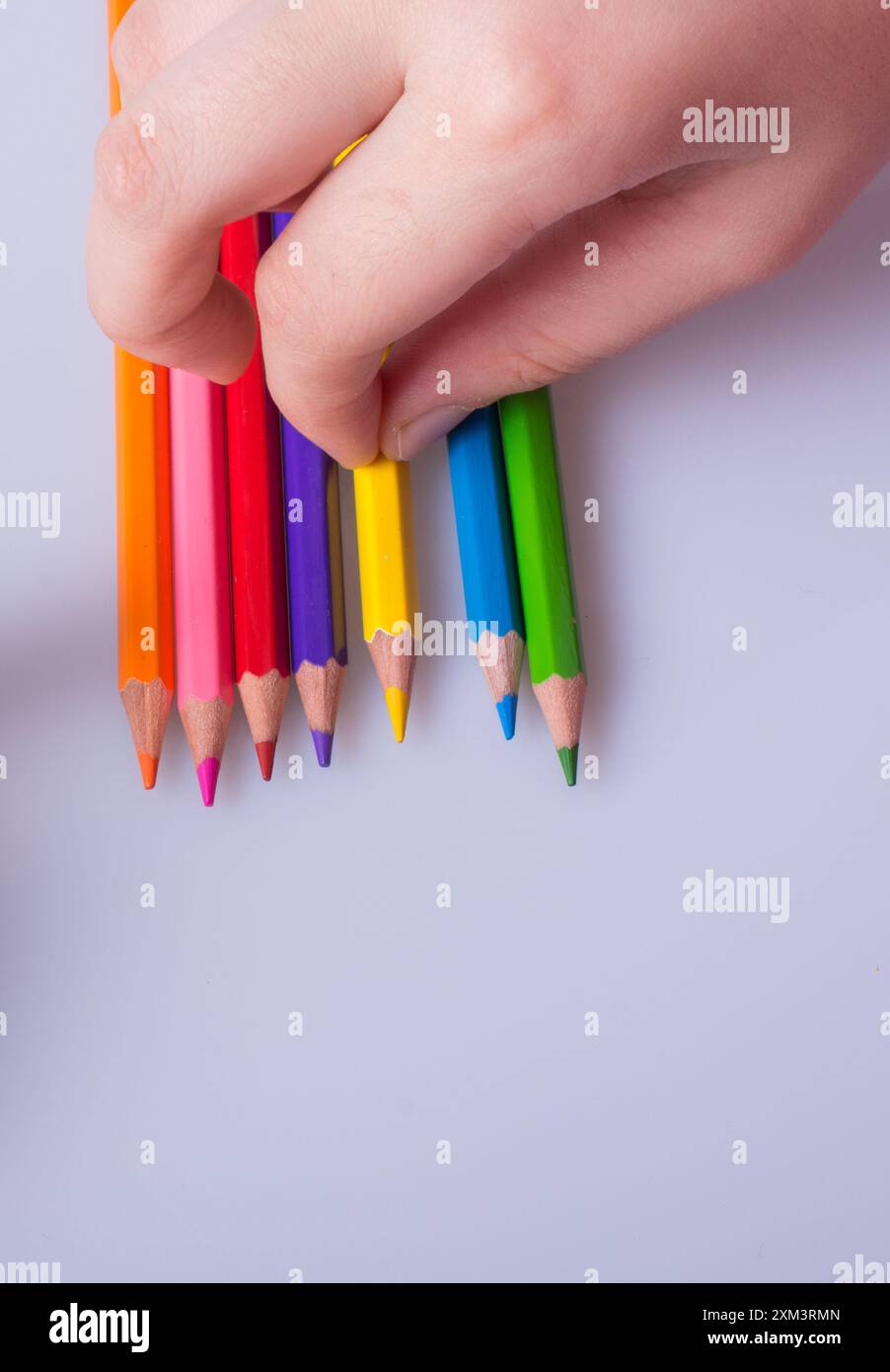 Hand holding color Pencils placed on a white background Stock Photo - Alamy