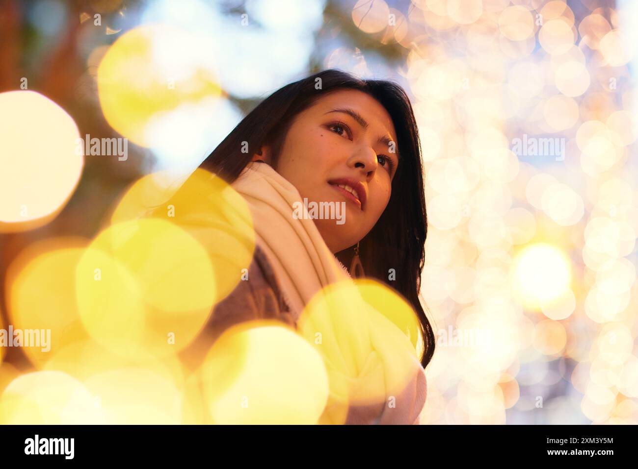 Asian Woman Looking Up At The Camera While Standing In Front Of A ...