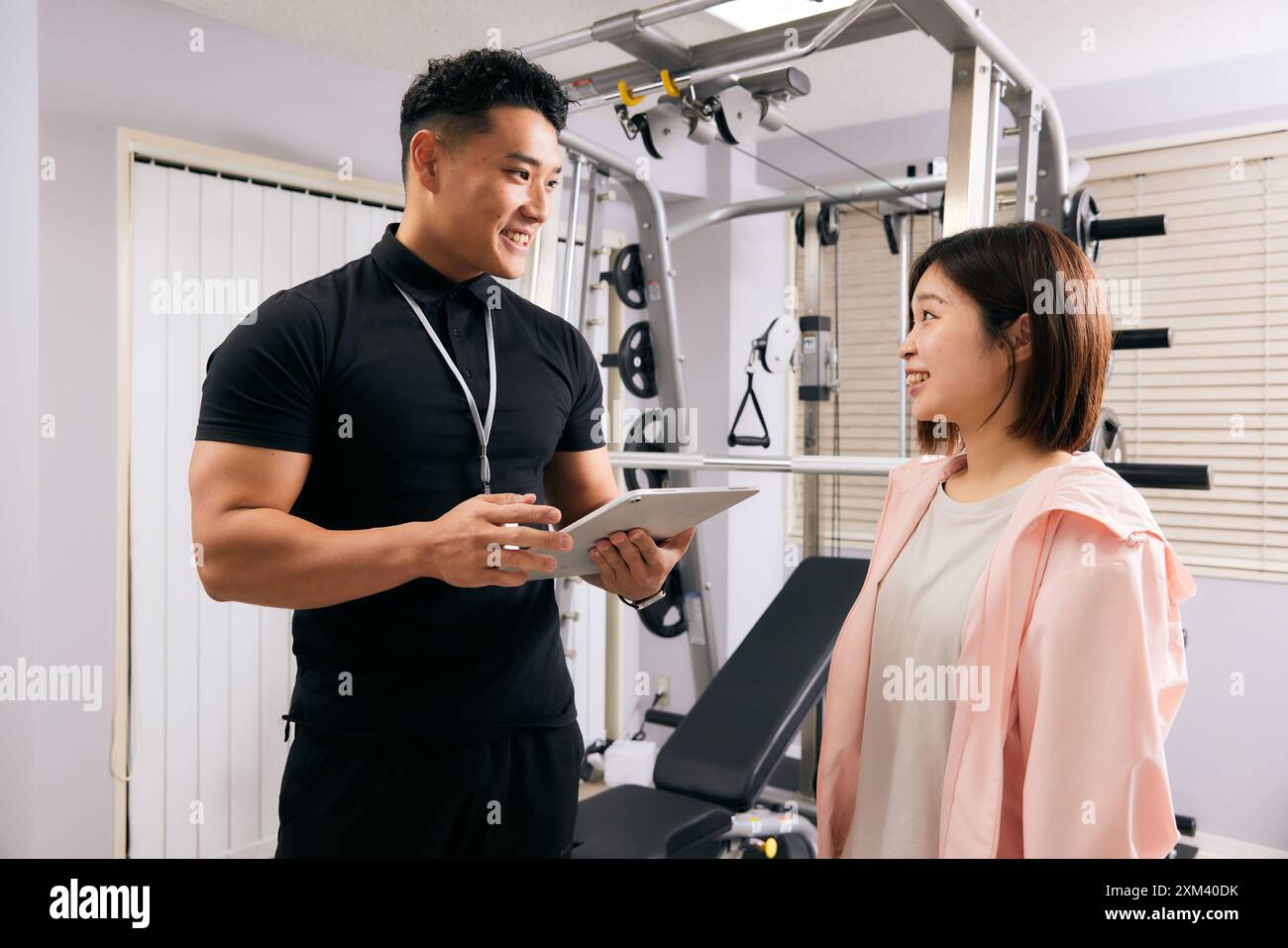Young woman personal trainer tablet hi-res stock photography and images ...