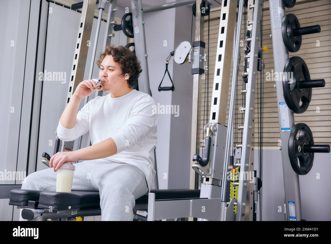 Asian Man Sitting On A Gym Machine Stock Photo - Alamy