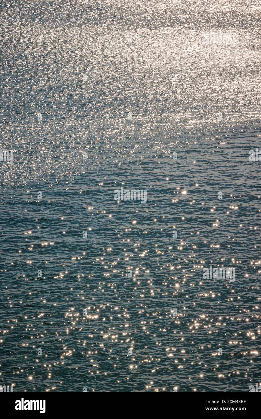 The sea sparkles in the sun off the coast of Noosa National Park in ...