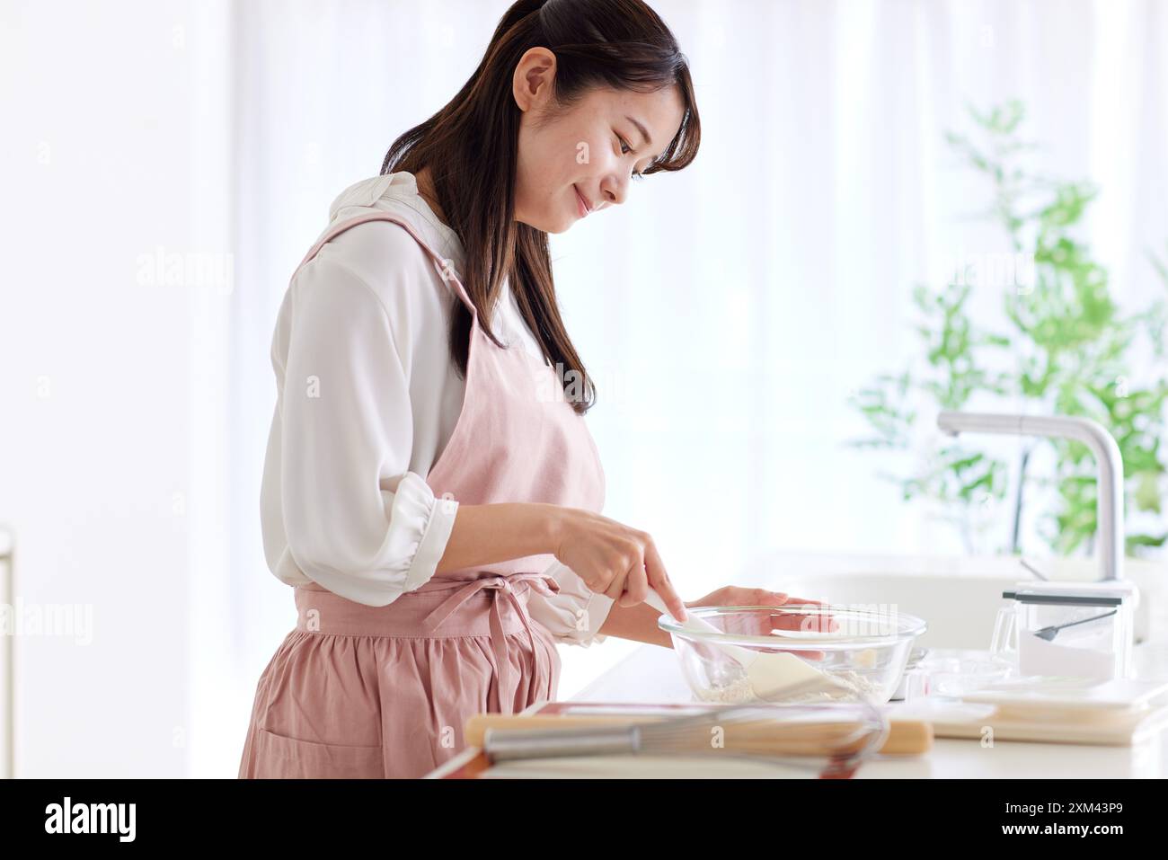 Japanese woman cooking in the kitchen Stock Photo - Alamy