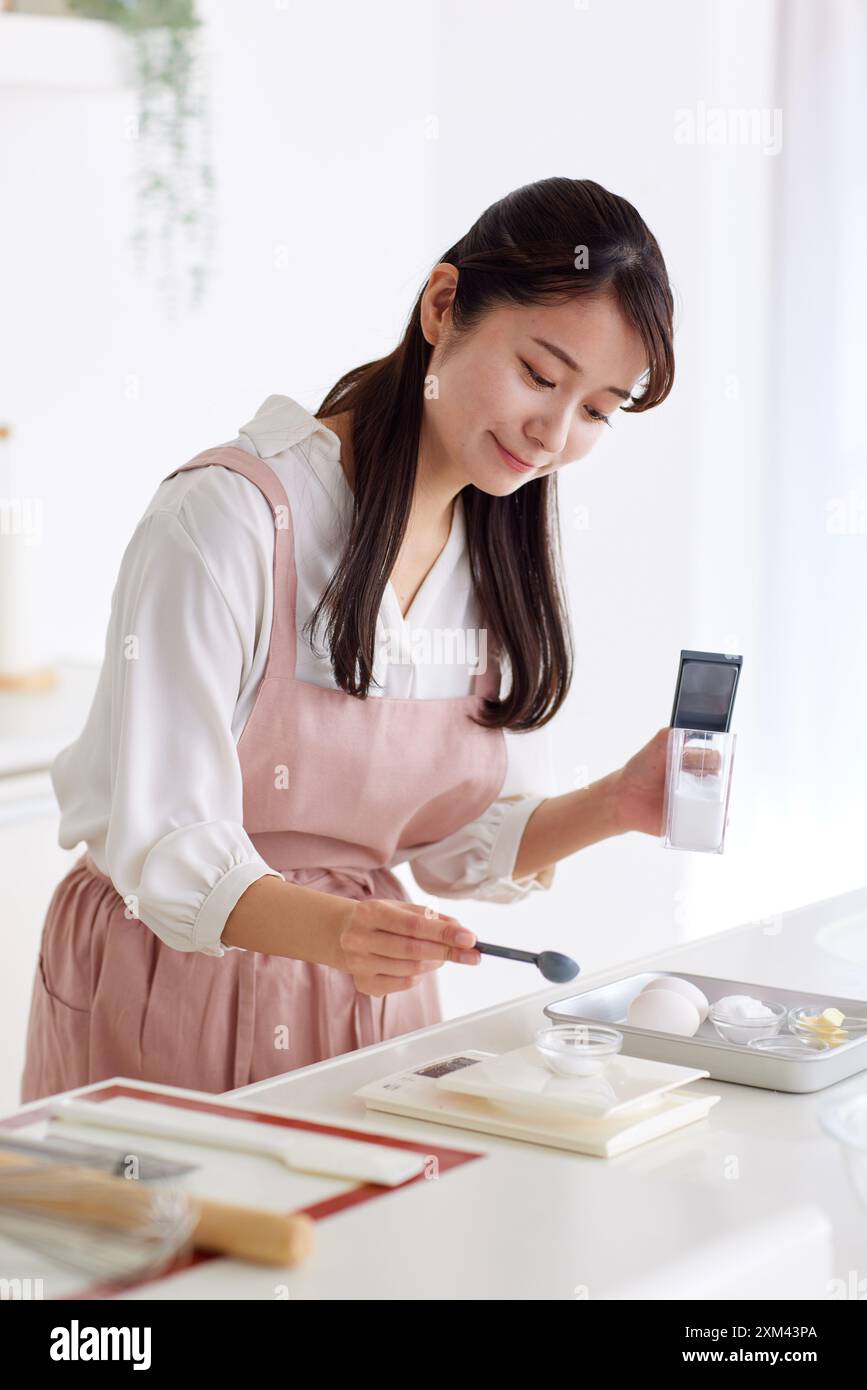 Japanese woman cooking in the kitchen Stock Photo - Alamy