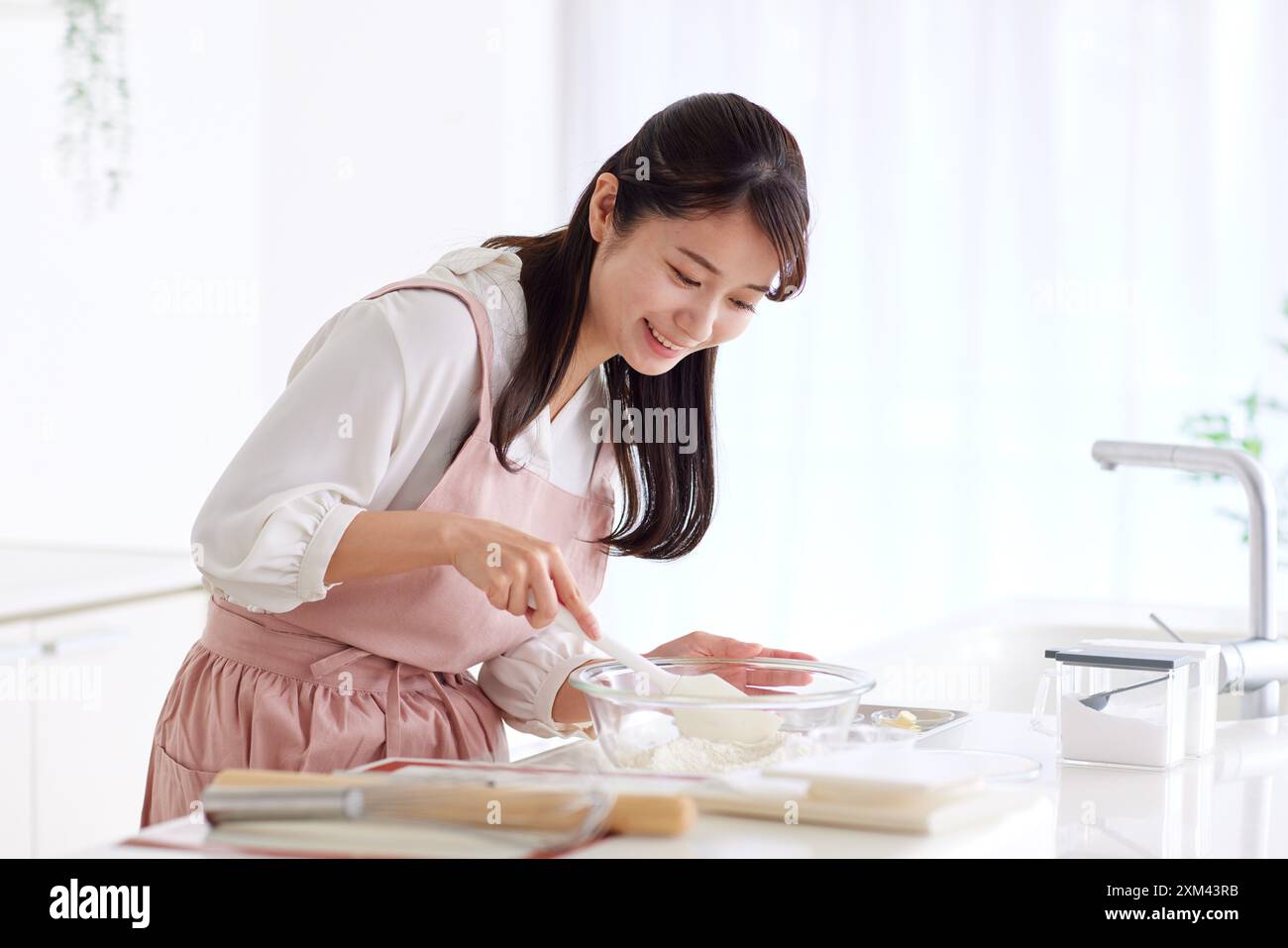 Japanese woman cooking in the kitchen Stock Photo - Alamy
