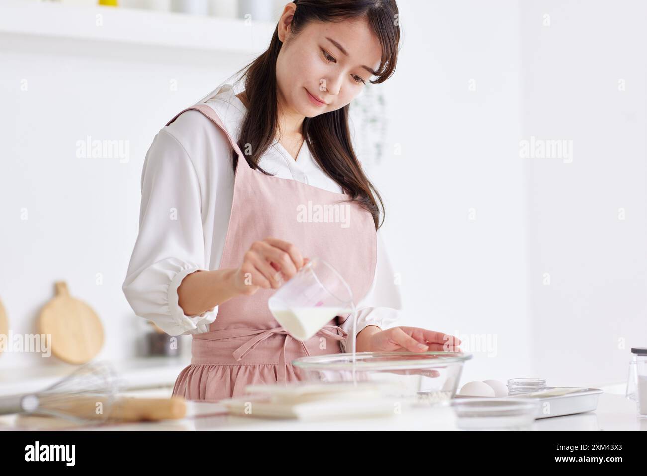 Japanese woman cooking in the kitchen Stock Photo - Alamy