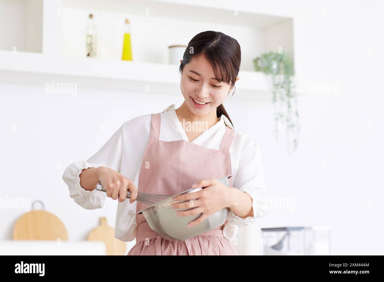 Japanese woman cooking in the kitchen Stock Photo - Alamy