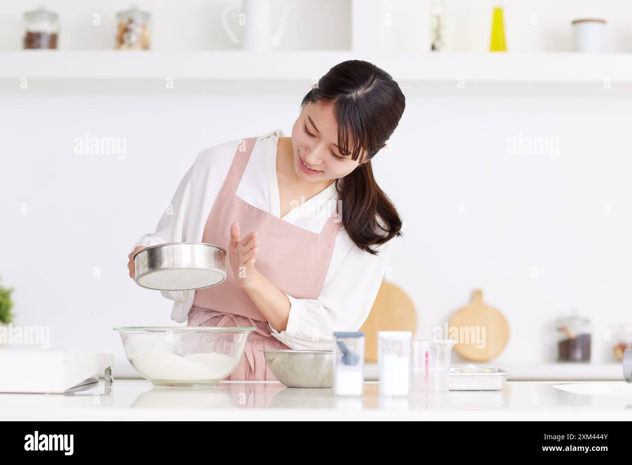 Japanese woman cooking in the kitchen Stock Photo - Alamy