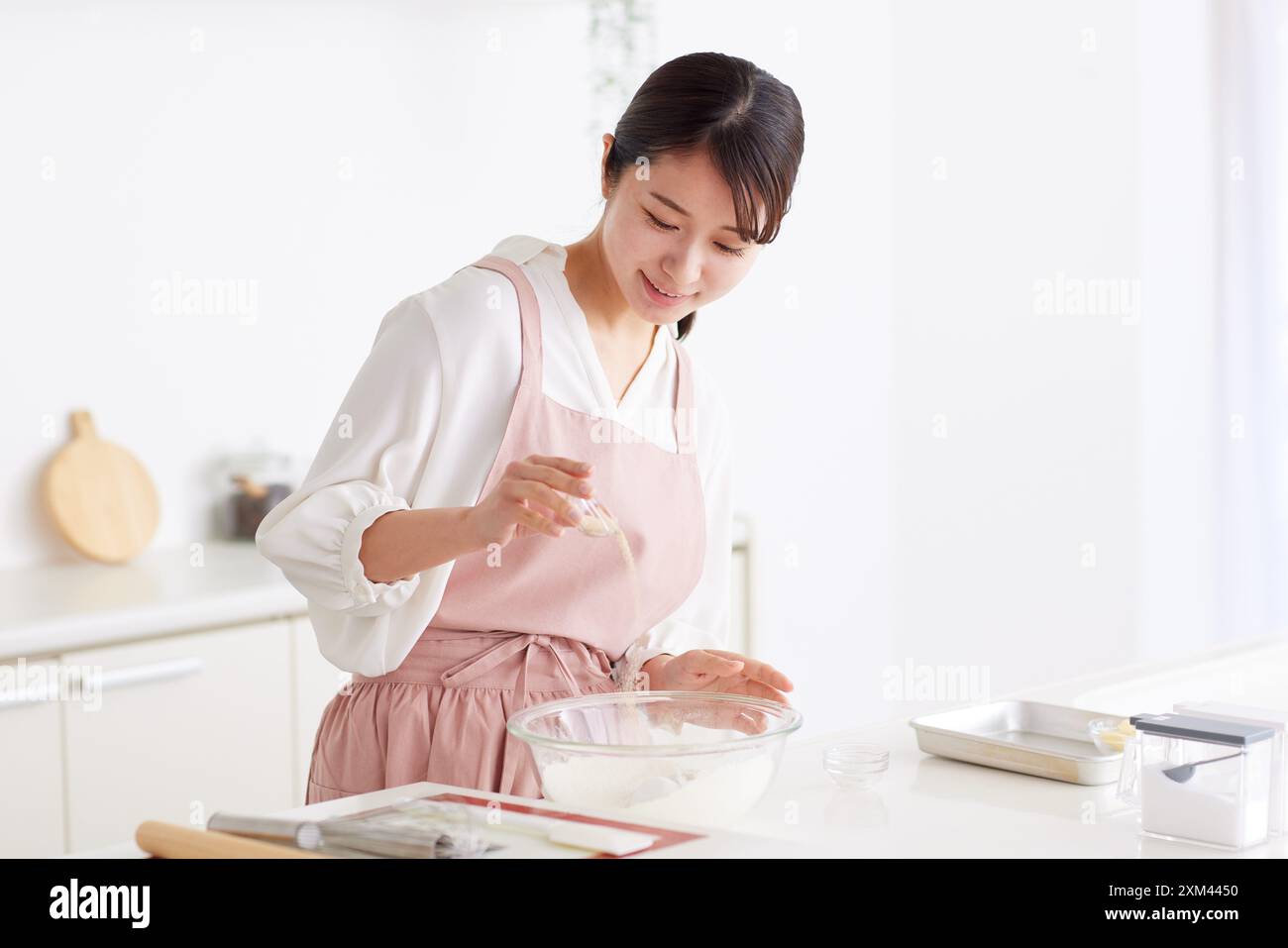Japanese woman cooking in the kitchen Stock Photo - Alamy