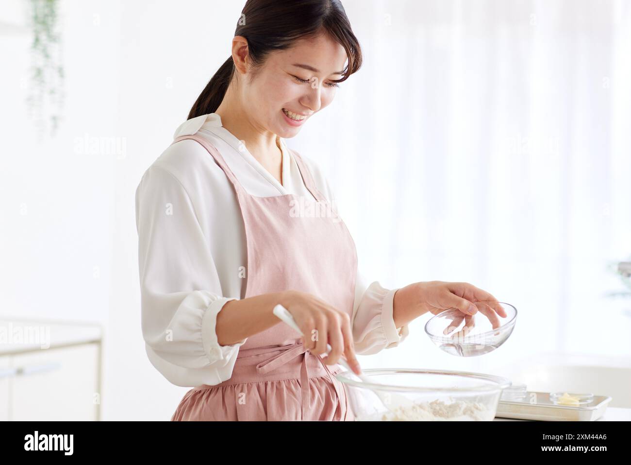 Japanese woman cooking in the kitchen Stock Photo - Alamy