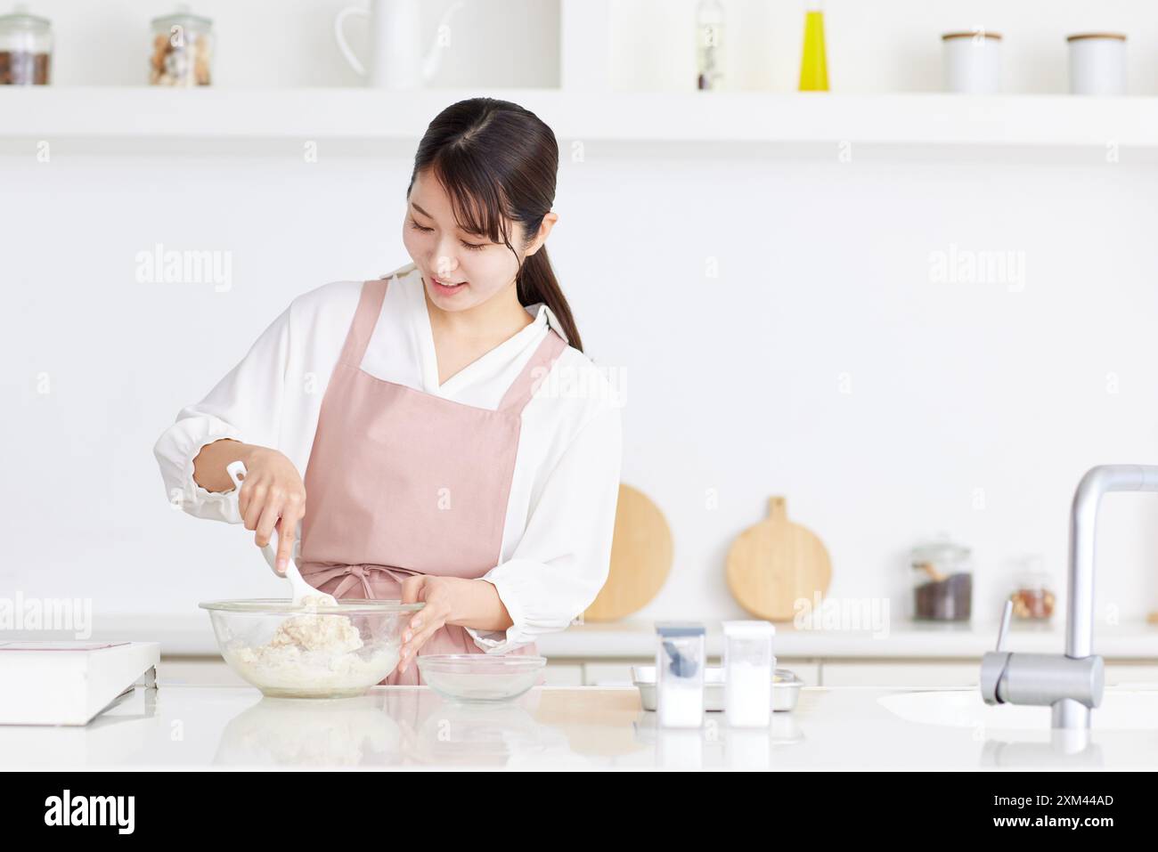 Japanese woman cooking in the kitchen Stock Photo - Alamy