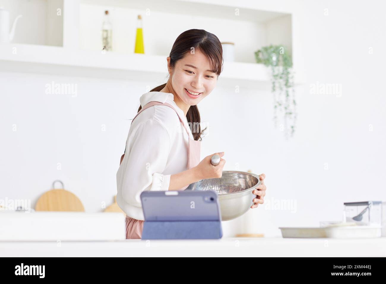 Japanese woman cooking in the kitchen Stock Photo - Alamy