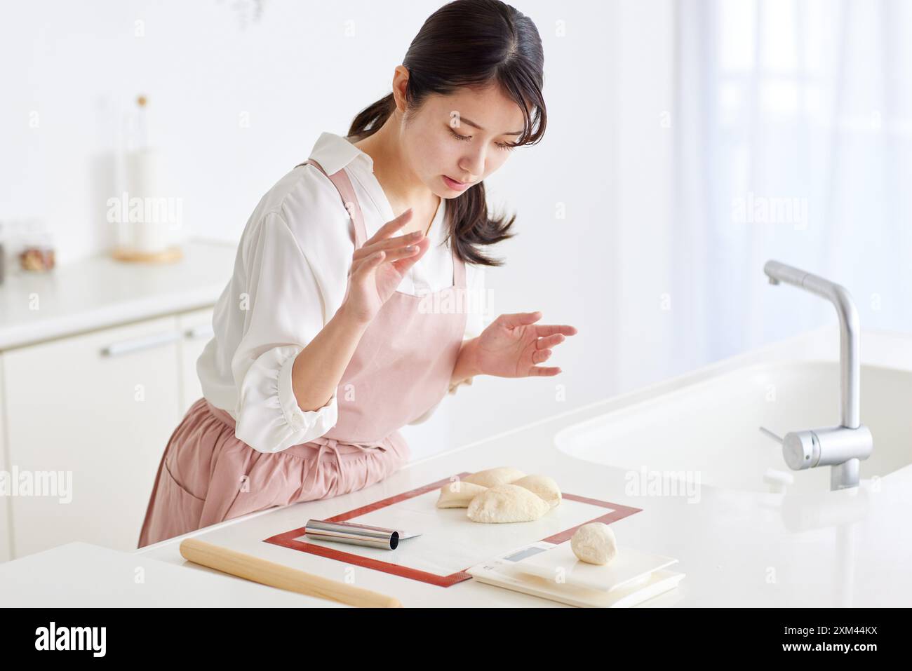 Japanese woman cooking in the kitchen Stock Photo - Alamy