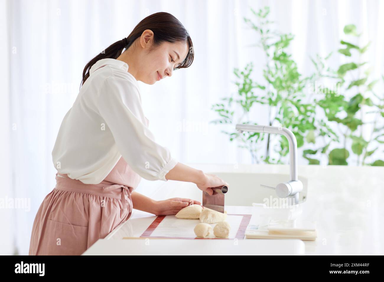 Japanese woman cooking in the kitchen Stock Photo - Alamy